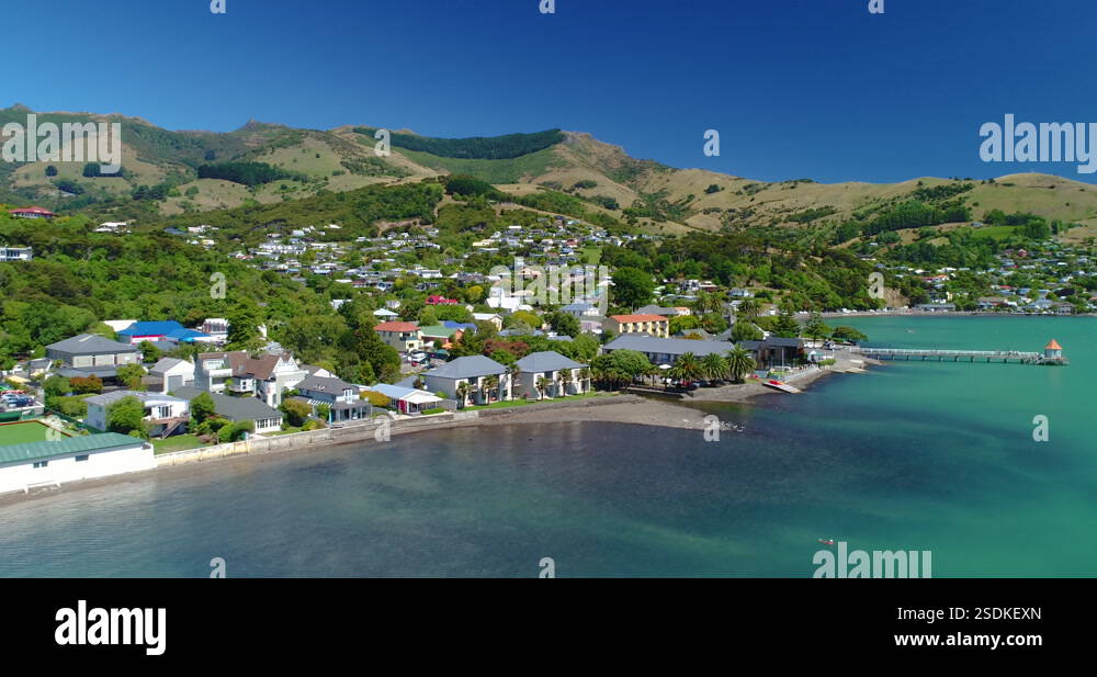 Aerial tracking view of harbour and waterfront at Akaroa,New Zealand ...
