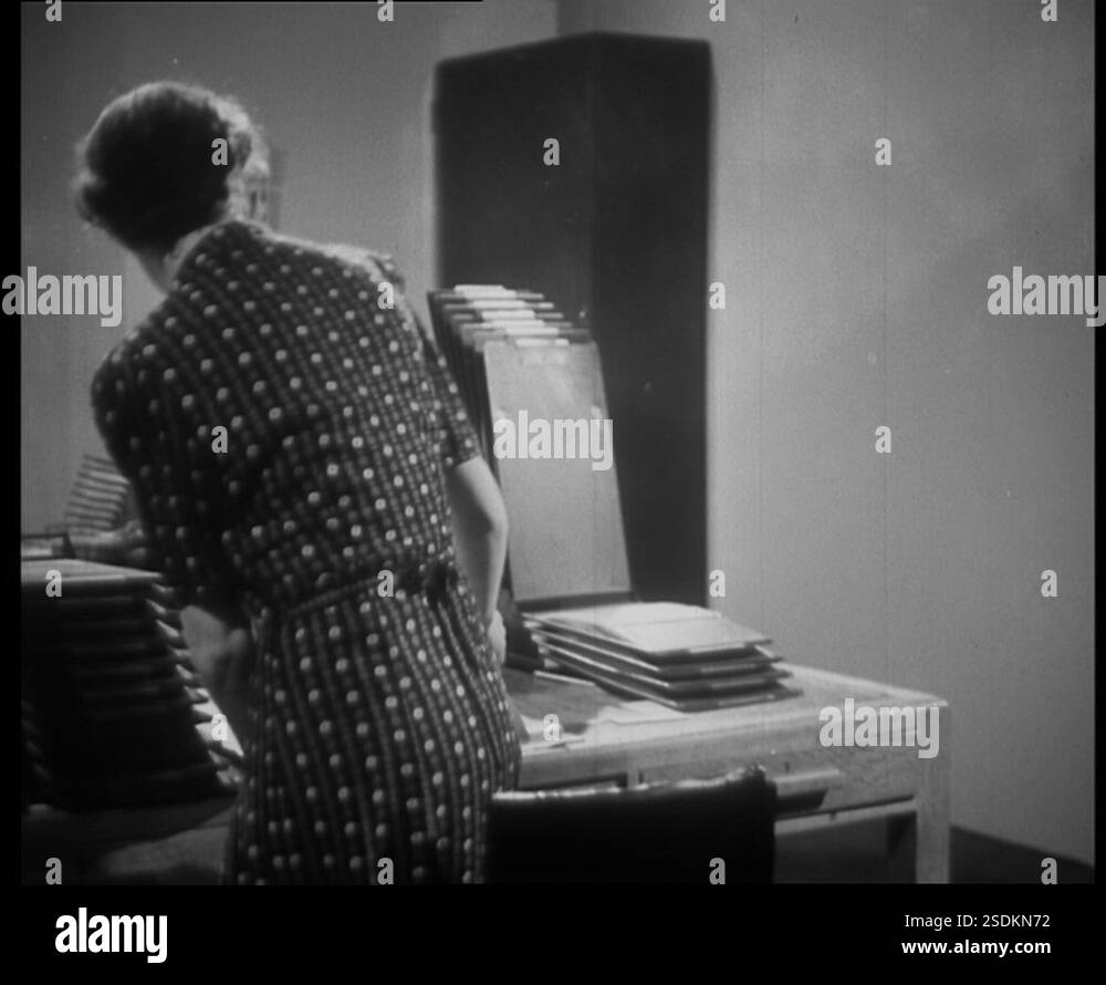 Women working in office on history charts for films, voice explains ...