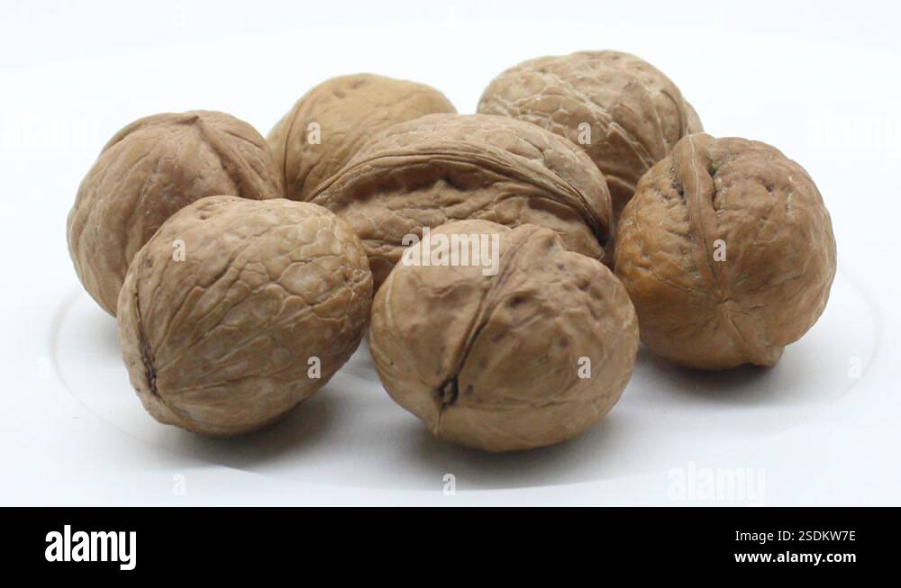 Dry walnuts on white background Stock Video Footage - Alamy