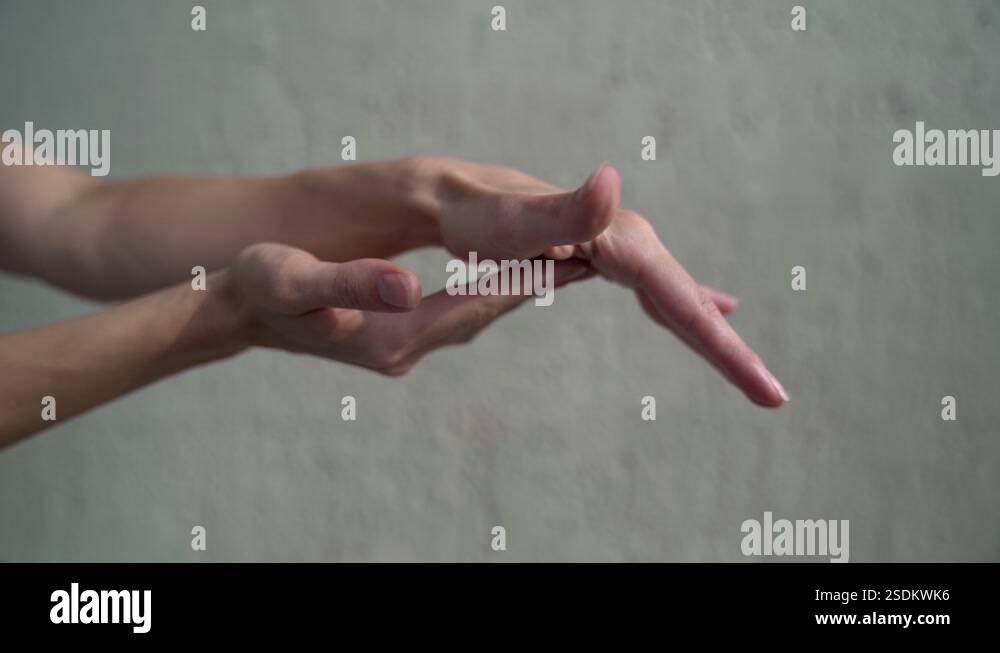 female hands are placed one under the other. the fingers slide on the ...