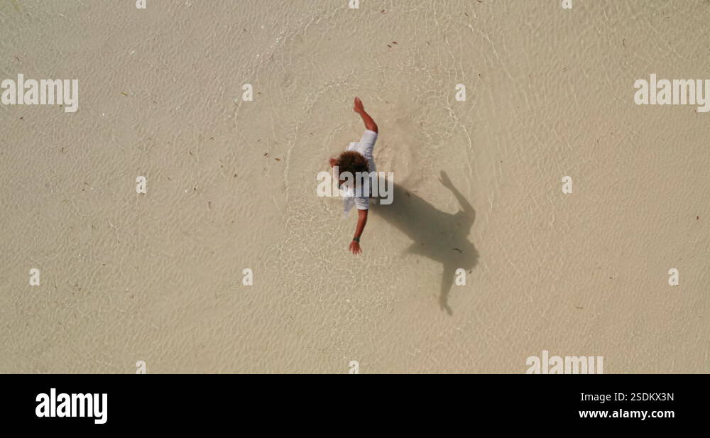 Aerial shot of overweight man having fun to dance on beach of tropical ...