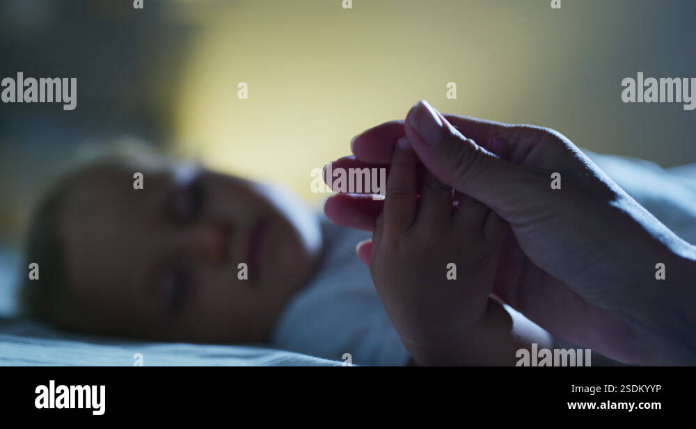 Close up of neo mother hand caressing her newborn baby while is ...