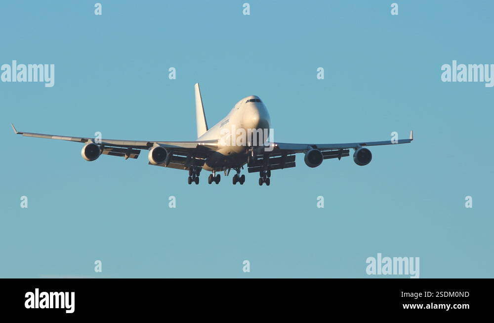 huge cargo airplane boeing 747 in flight passing close overhead sunny ...