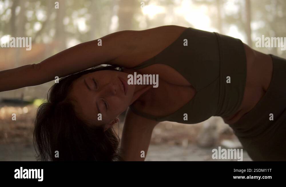 Portrait of a girl doing yoga in wooden hut filled with light, the girl ...