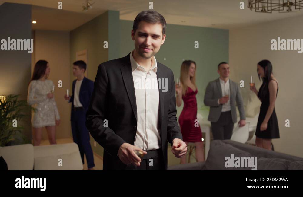 Man dancing with champagne flute at party Stock Video Footage - Alamy