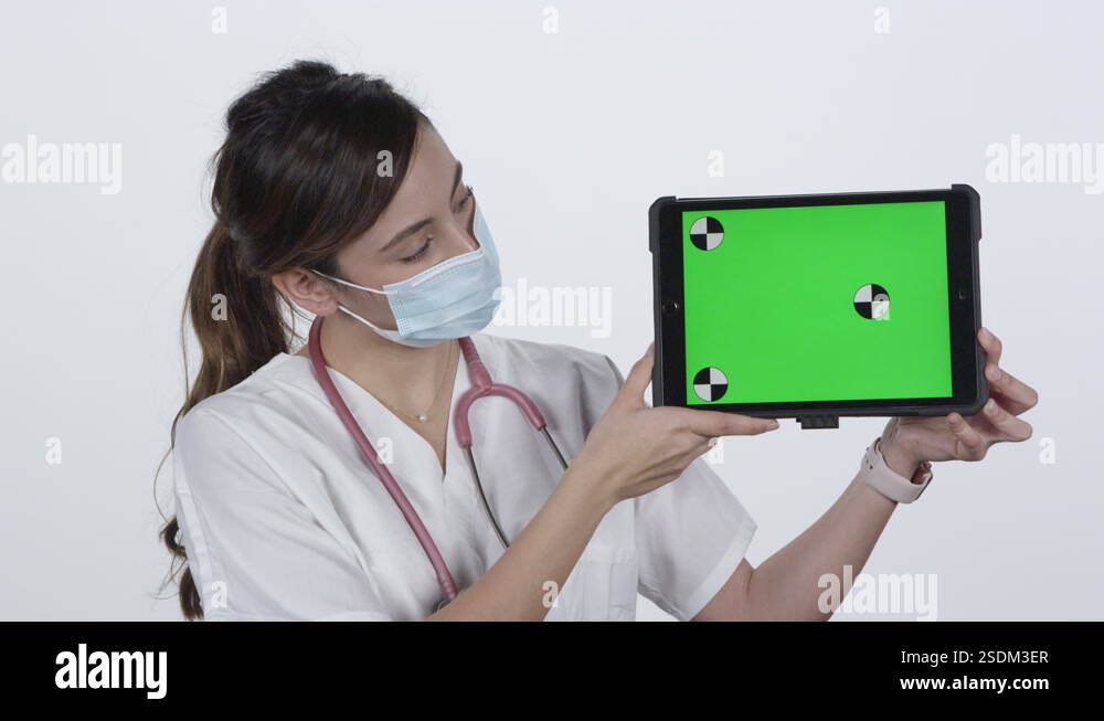 Medical professional holding up tablet with green screen Stock Video ...