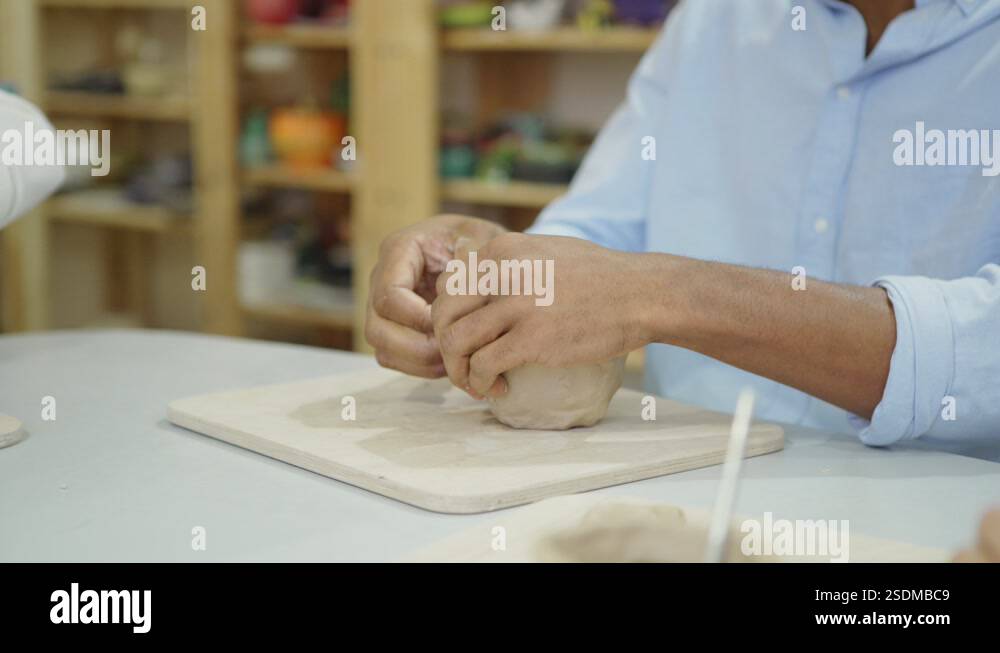 Group of diverse people shaping clay bowls in art studio Stock Video ...