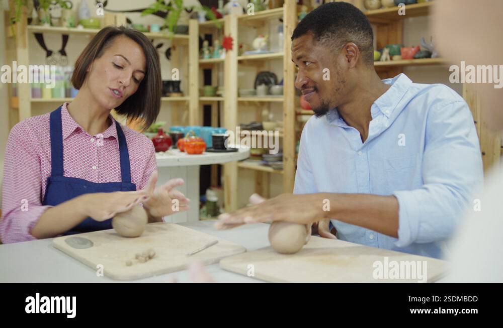 Three diverse people wedging clay in ceramic studio Stock Video Footage ...