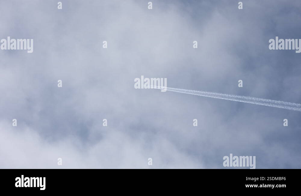 Passenger Airplane Flying At High Altitude With Contrail Against Blue ...