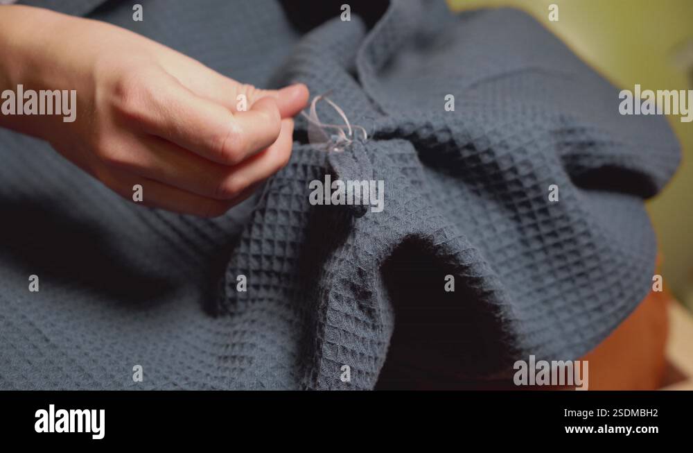 Women's hands with thread and needle sews torn clothes Stock Video ...