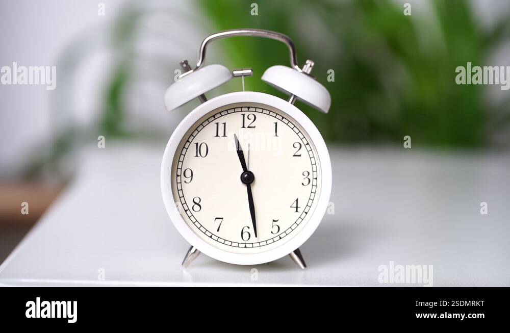 timelapse. The hands on the dial of the white alarm clock is moving ...