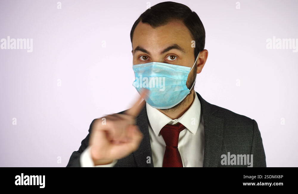 Handsome Man in Business Suit and Protective Medical Mask waving his ...