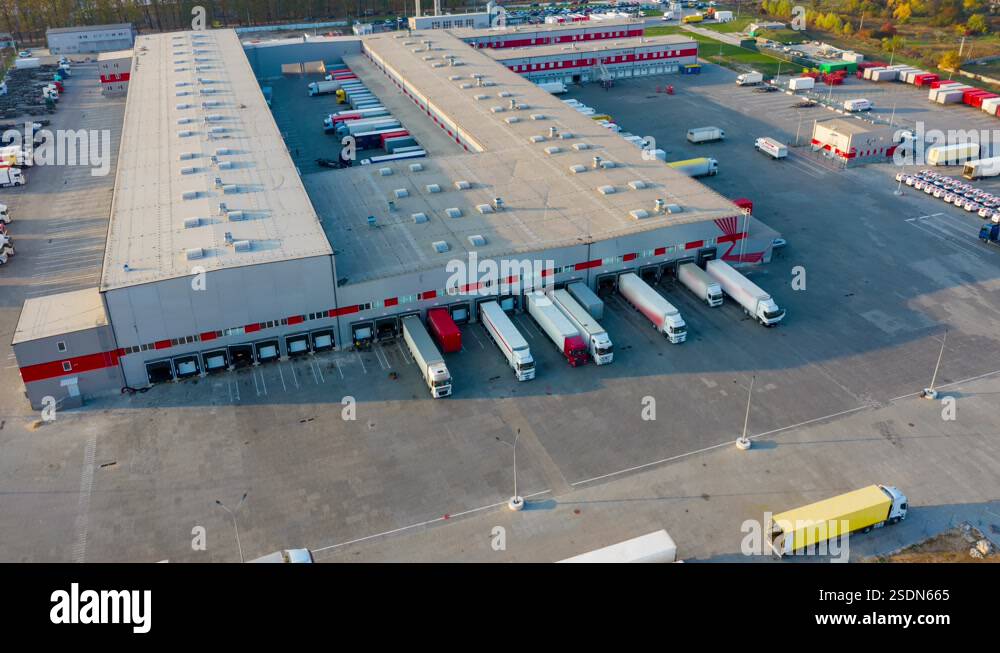 Logistics park with a warehouse - loading hub. Semi-trucks with freight ...
