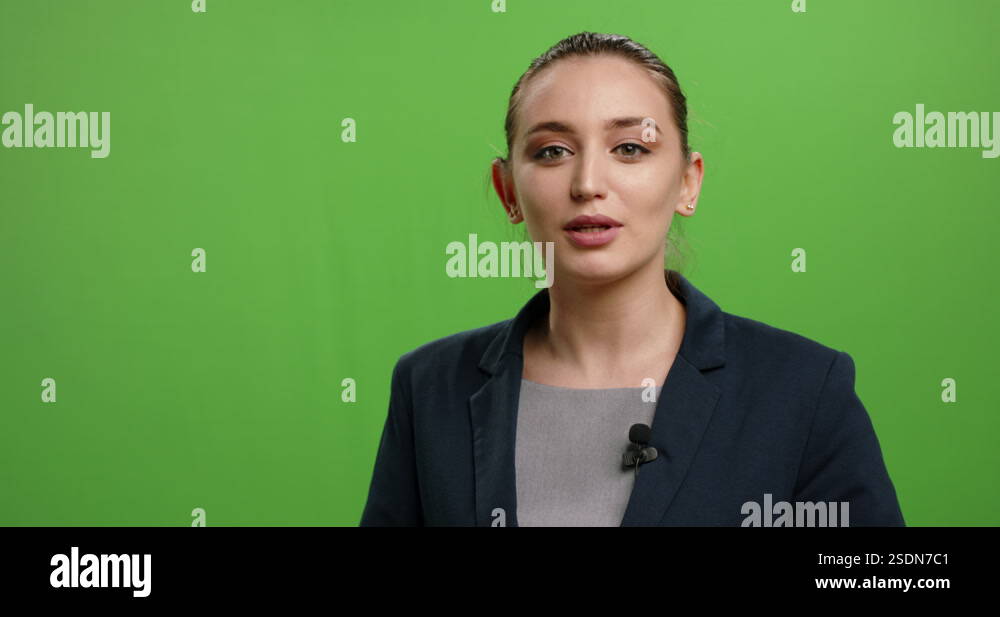 Female news anchor looking at camera and talking during broadcast ...