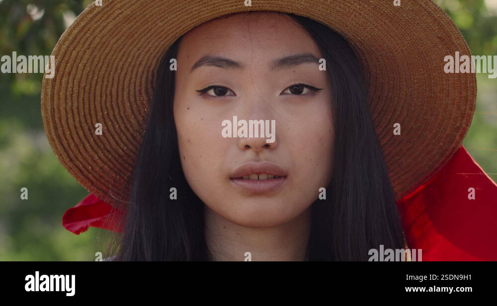 Headshot of attractive asian female model with long dark hair looking ...