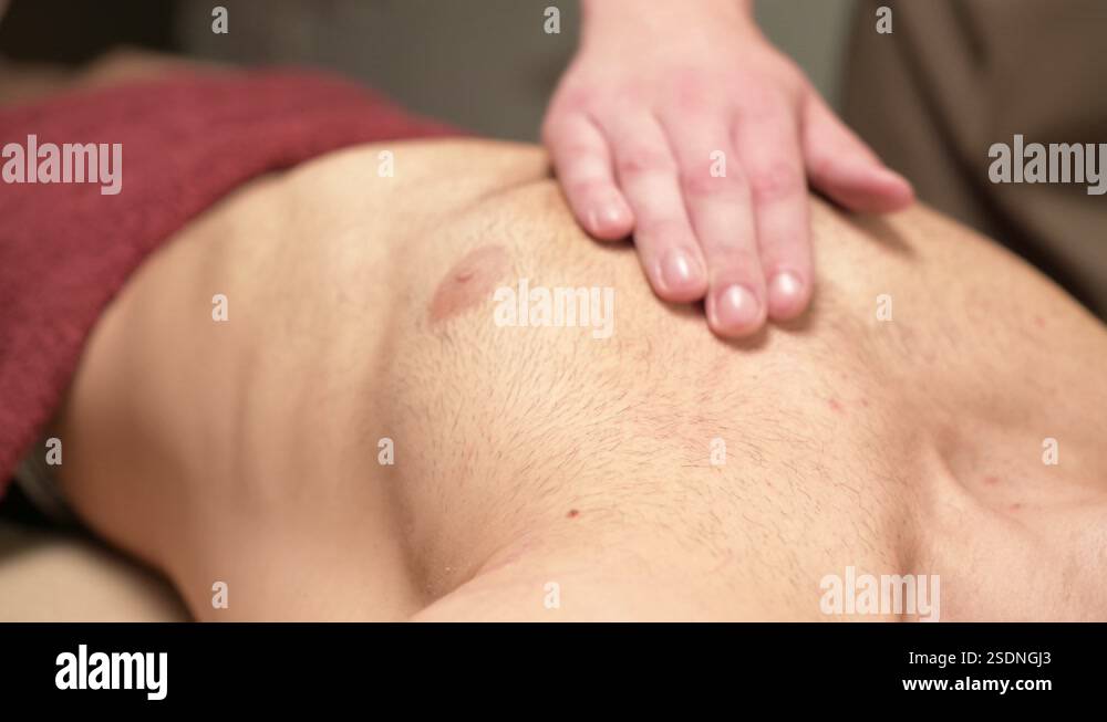 Sports massage of the pectoral muscles and solar plexus for a male ...