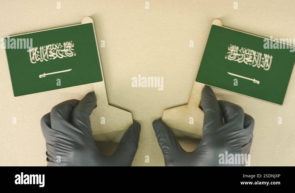 Flags of Saudi Arabia made of recycled paper on the cardboard table ...