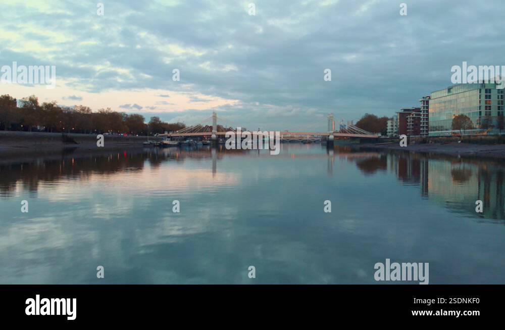 dolly forward rising reveal drone shot of Albert bridge and London city ...