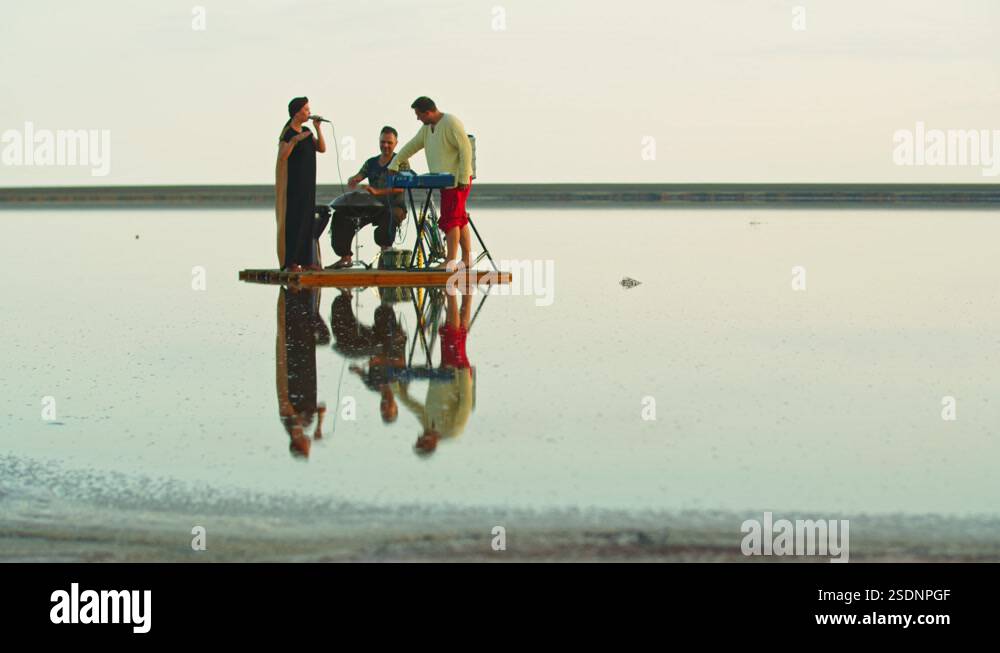 Band on a little raft is floating in the sea while playing relaxing ...