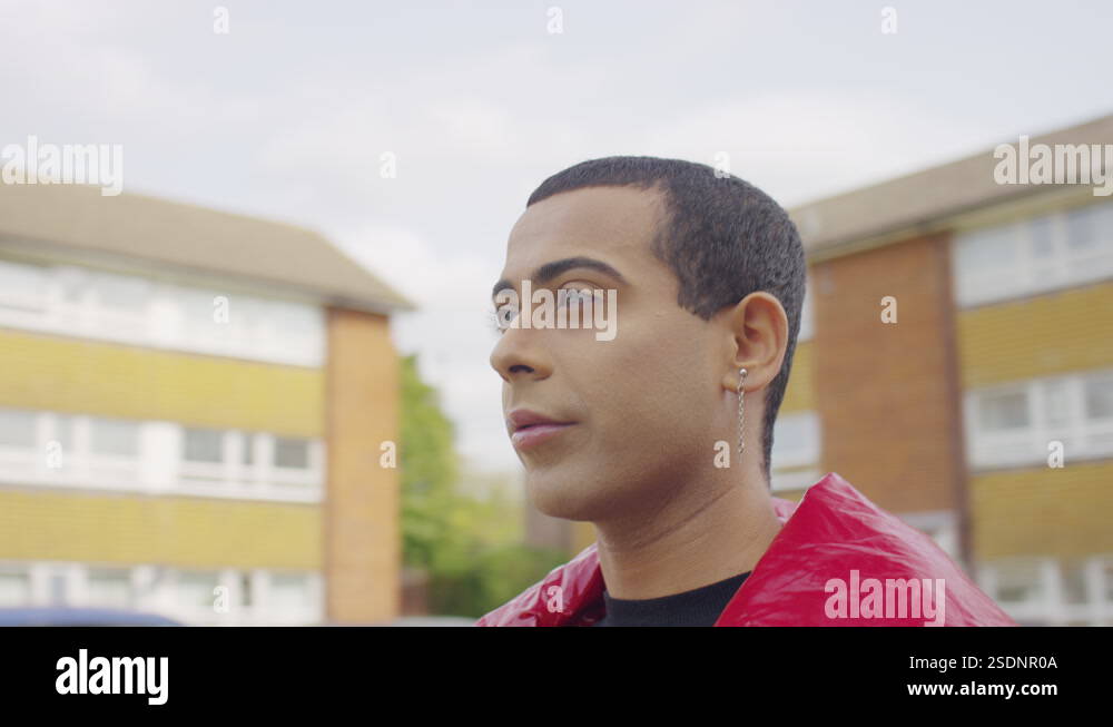Portrait of camera circling an androgynous male standing outside ...
