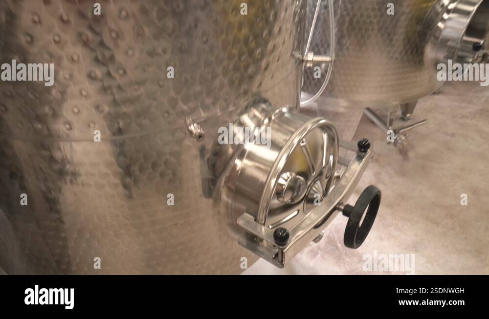 Pan up reveal stainless steel vats used to ferment wine, viticulture ...