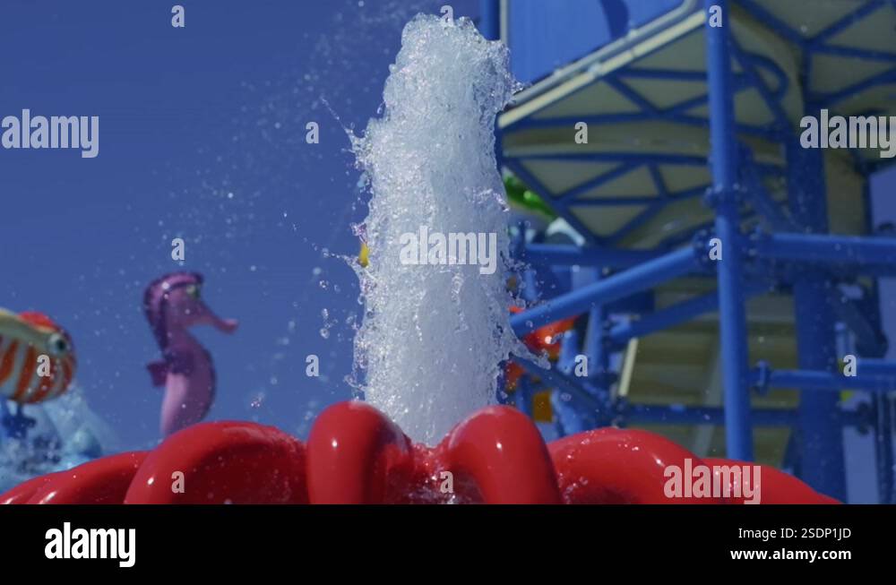 The water pouring from the tree figure in the aqua park. close-up shot ...