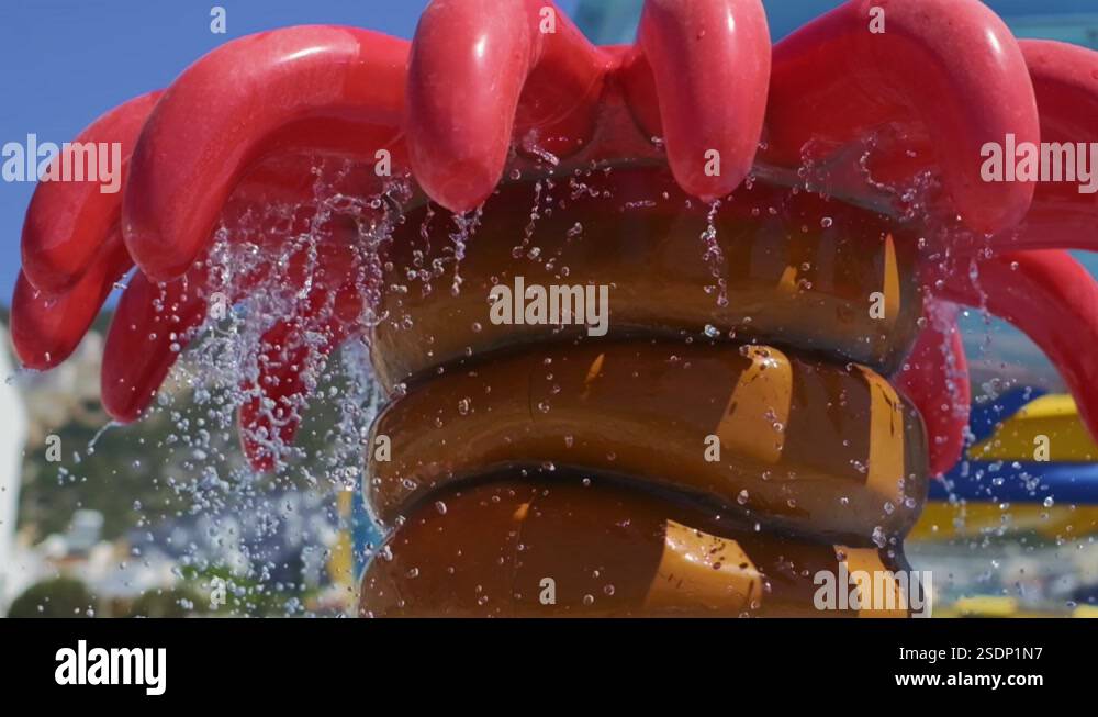 The water pouring from the tree figure in the aqua park. close-up shot ...