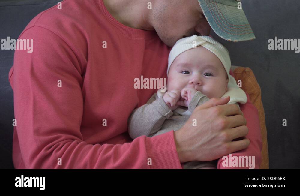 New father kissing baby in the head and smells her hear when little ...