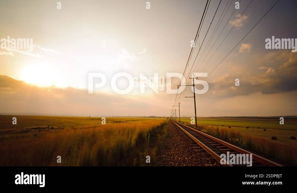 Static late afternoon timelapse of railway track in rural landscape ...