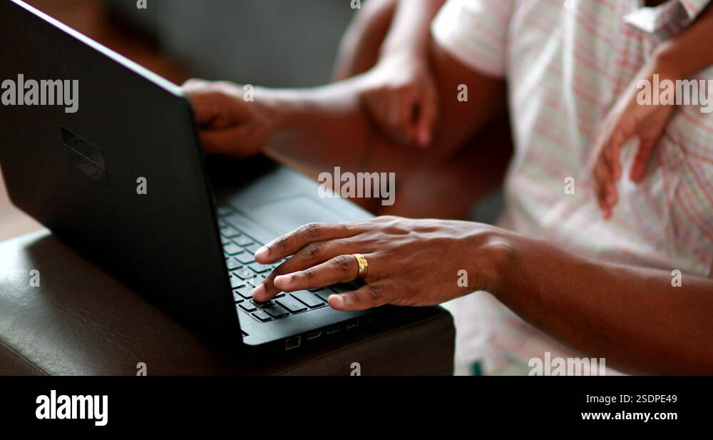 African parent using laptop computer with child son Stock Video Footage ...
