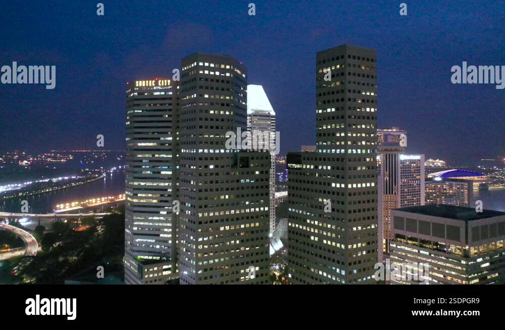 Night view of the Suntec City mall and cityscape view of high-rise ...