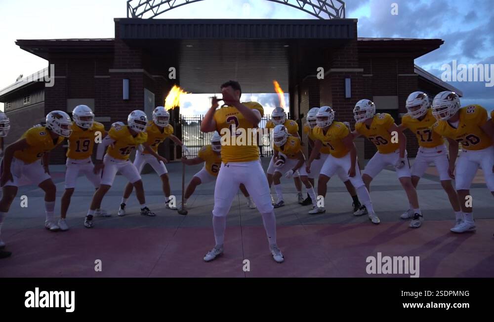 Football team getting motivated with fire spinning player before a game ...