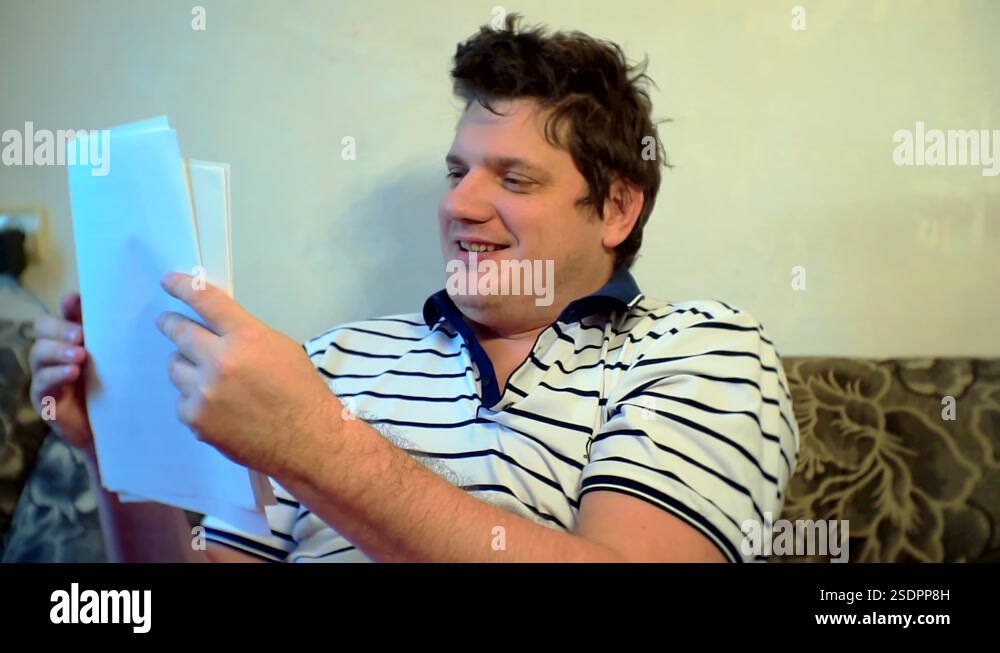 Men reading paper documents sitting on the couch Stock Video Footage ...