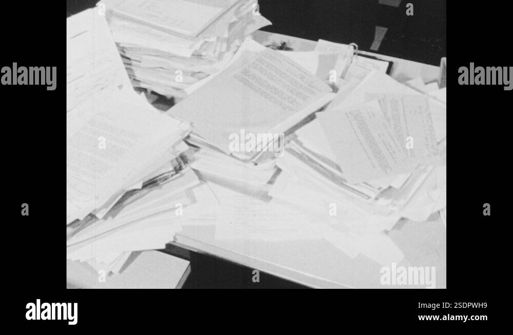 1960s: pile of papers growing on desk into large stacks, woman typing ...
