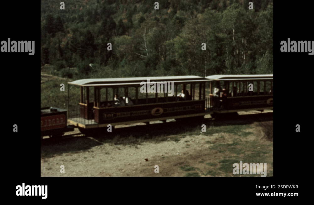 1950s: Train on tracks, people riding in passenger cars. Locomotive on ...