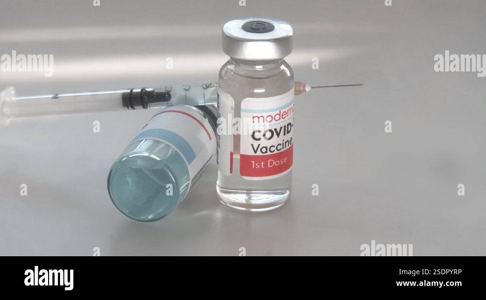 A Moderna 1st dosis and a 2nd dosis of covid-19 vaccine on a vial ...