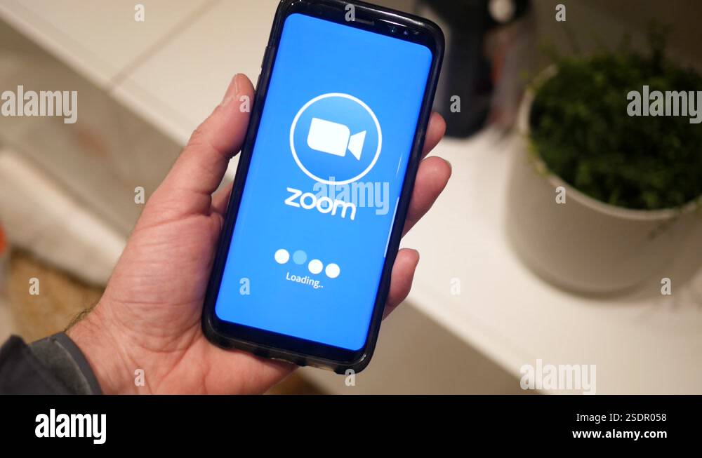 Zoom Video Conference app Loading on a Smartphone Screen Stock Video ...