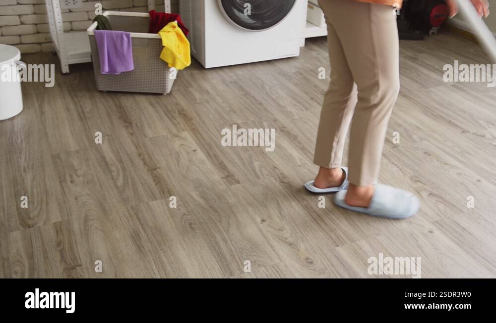 Young Asian woman doing chores housework using dust mop sweeping to ...