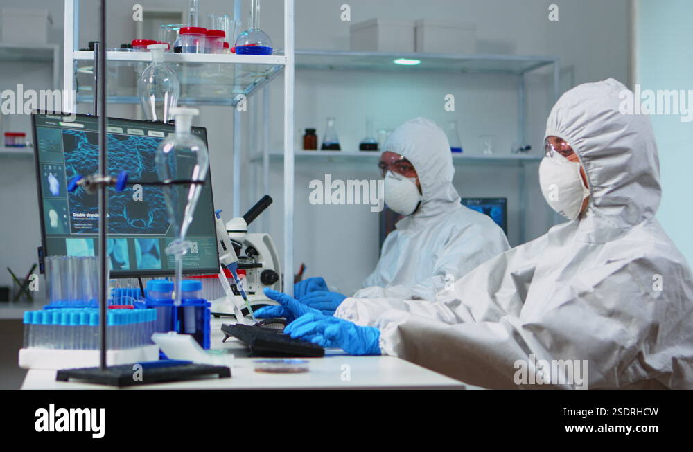 Scientists in protection suits working in chemical lab Stock Video ...