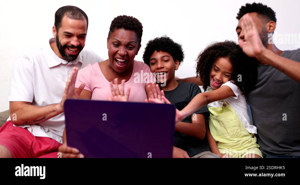 Black family waving hello or good bye to relative on video conference ...