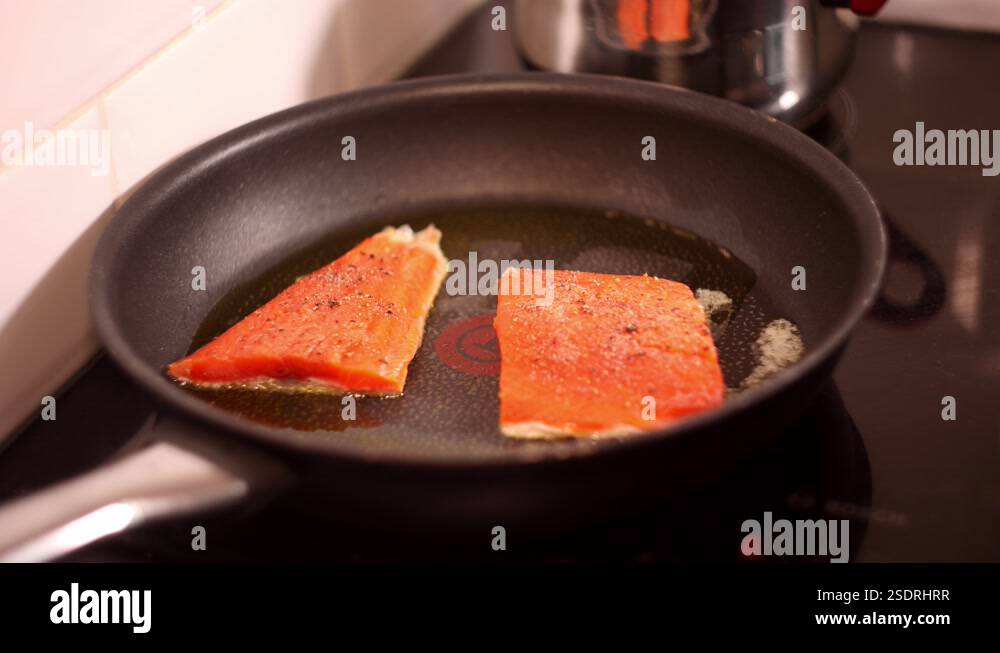 Frying salmon fillet on a pan Stock Video Footage - Alamy