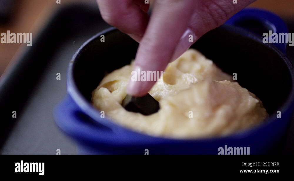 Adding chunks of dark chocolate to cake mixture Stock Video Footage - Alamy