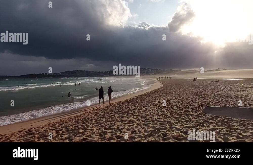 People on a sand beach before the storm. Families and friends relaxing ...