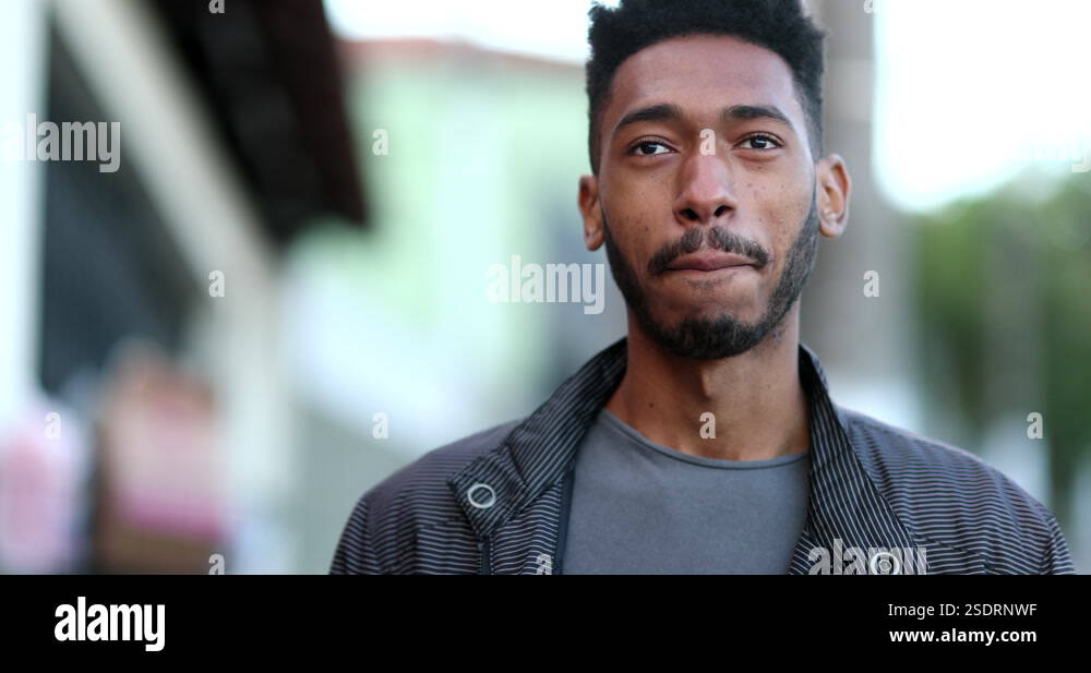Mixed race young man walking outside in sidewalk. Confident black ...