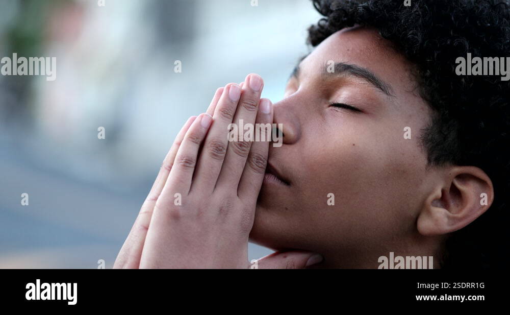 Young boy praying to God. Religious Mixed race child looking at sky ...