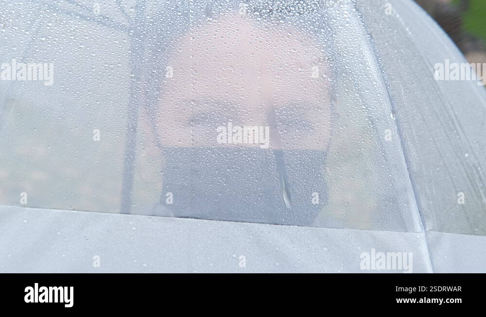 Hide from rain under umbrella Stock Video Footage - Alamy