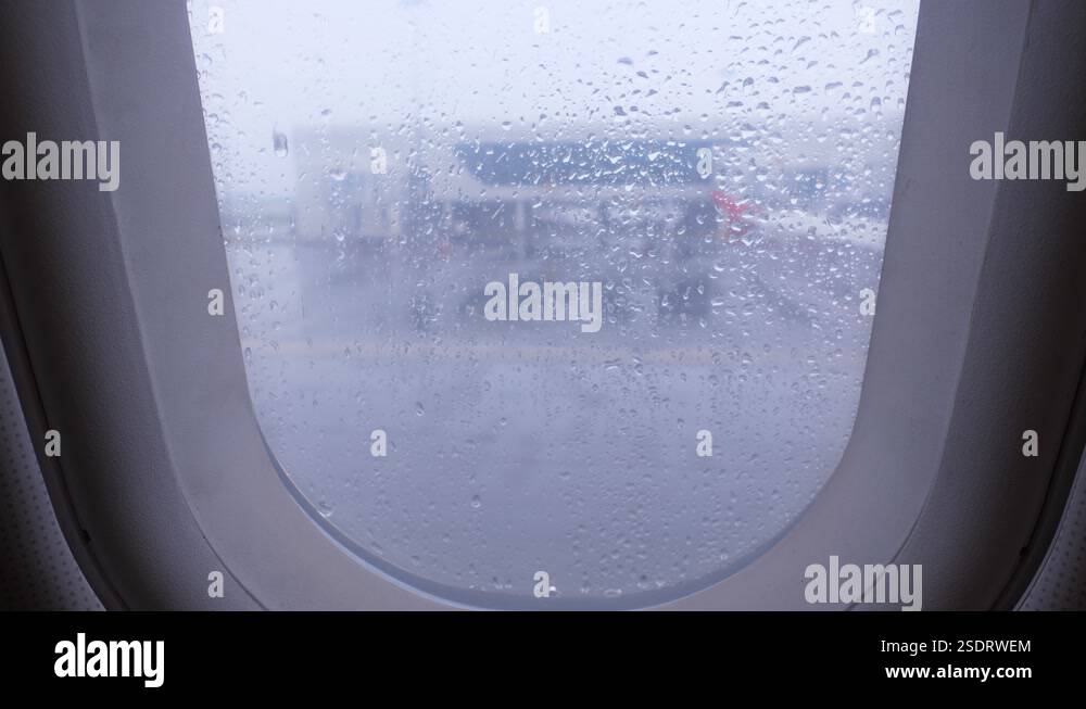 Two raindrops slide down by glass of airliner window, view from inside Stock Video Footage - Alamy