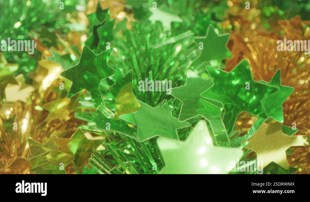 Golden and green tinsel holiday garlands macro dolly shot Stock Video ...