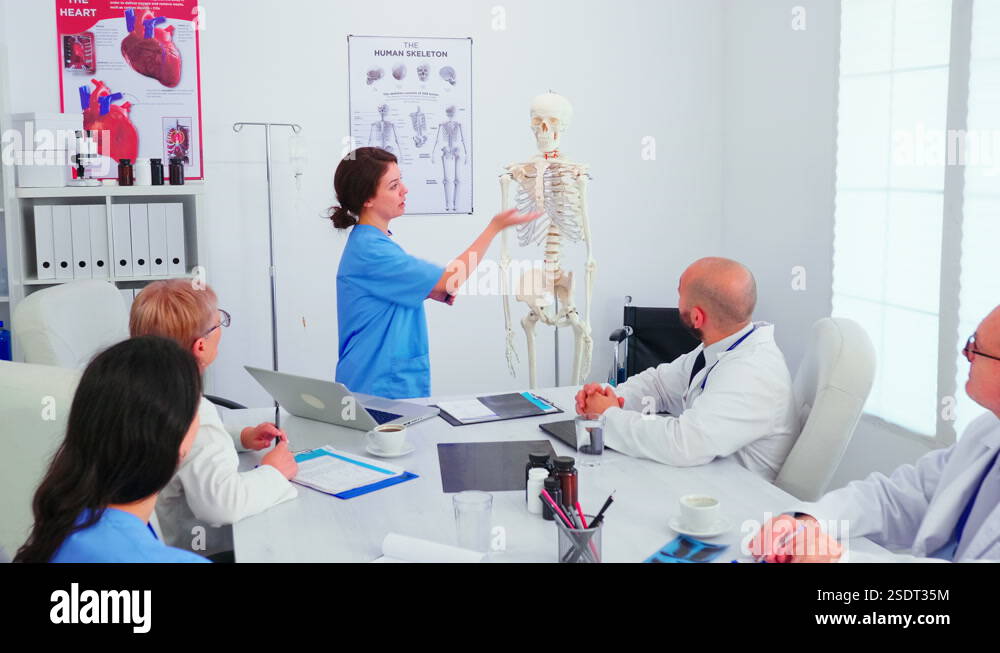 Assistent pointing on skeleton in front of medical stuff Stock Video ...