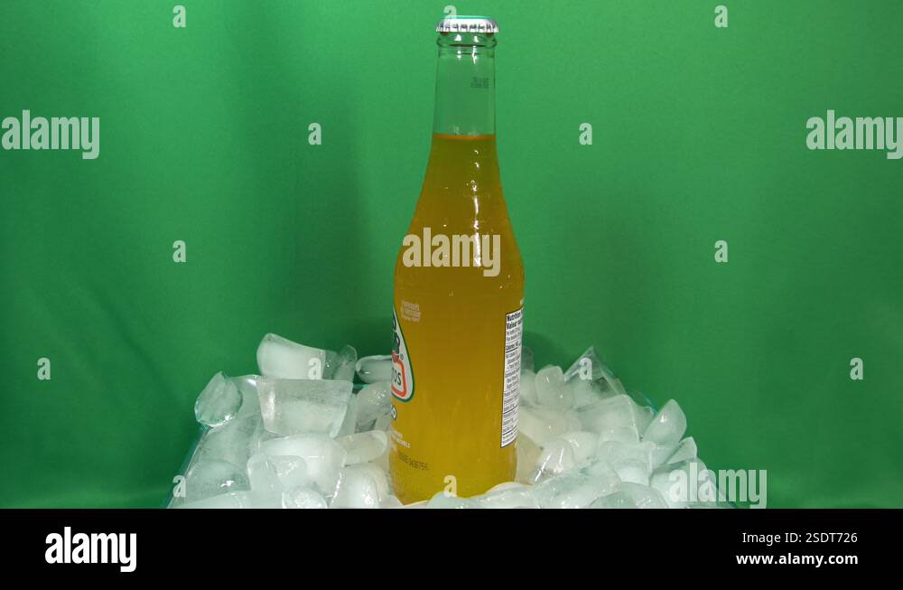1-2 Carbonated Mango Drink Bottle Rotating 360 degrees on stacked ice ...